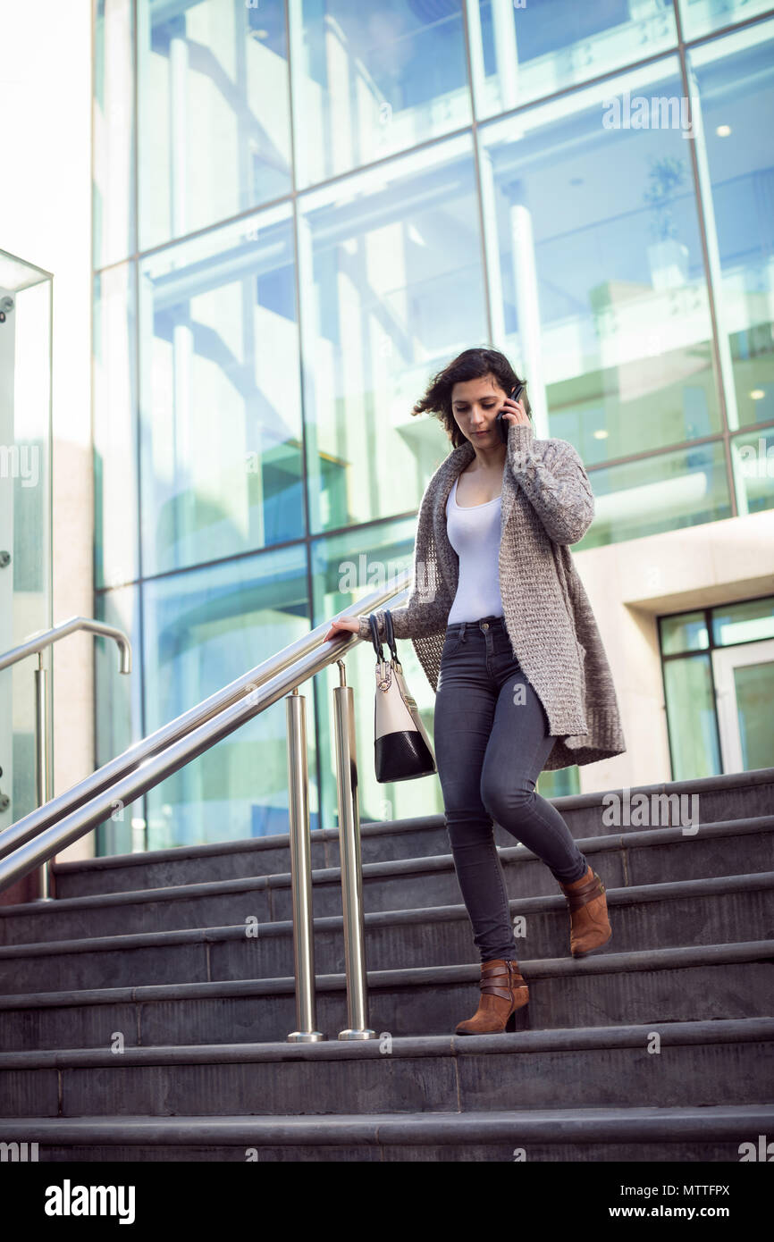 Woman walking downstairs hi-res stock photography and images - Alamy