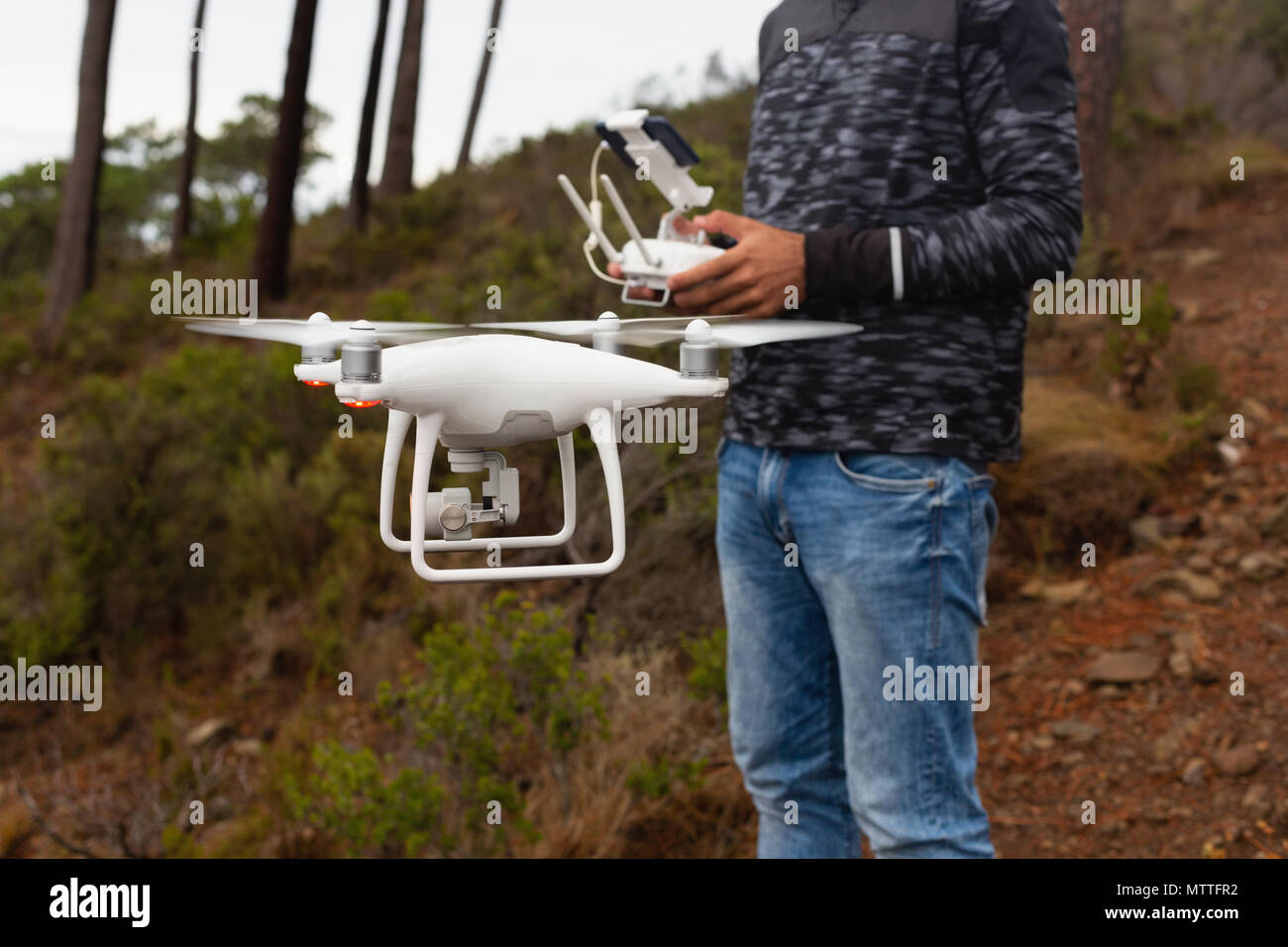 Man operating a flying drone Stock Photo - Alamy