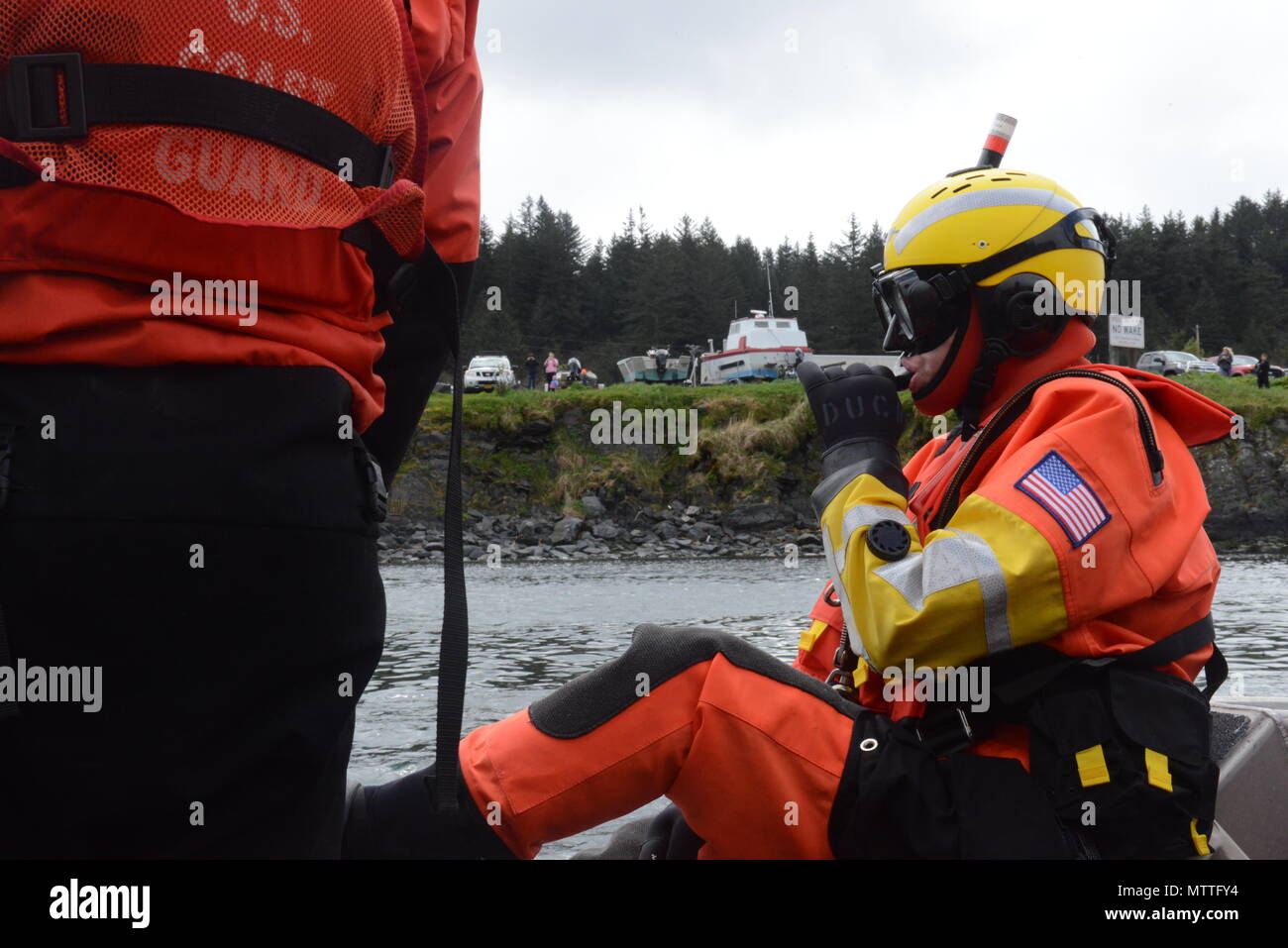 Coast Guard Seaman Apprentice Nicholas Barnes prepares to exit the 38 ...