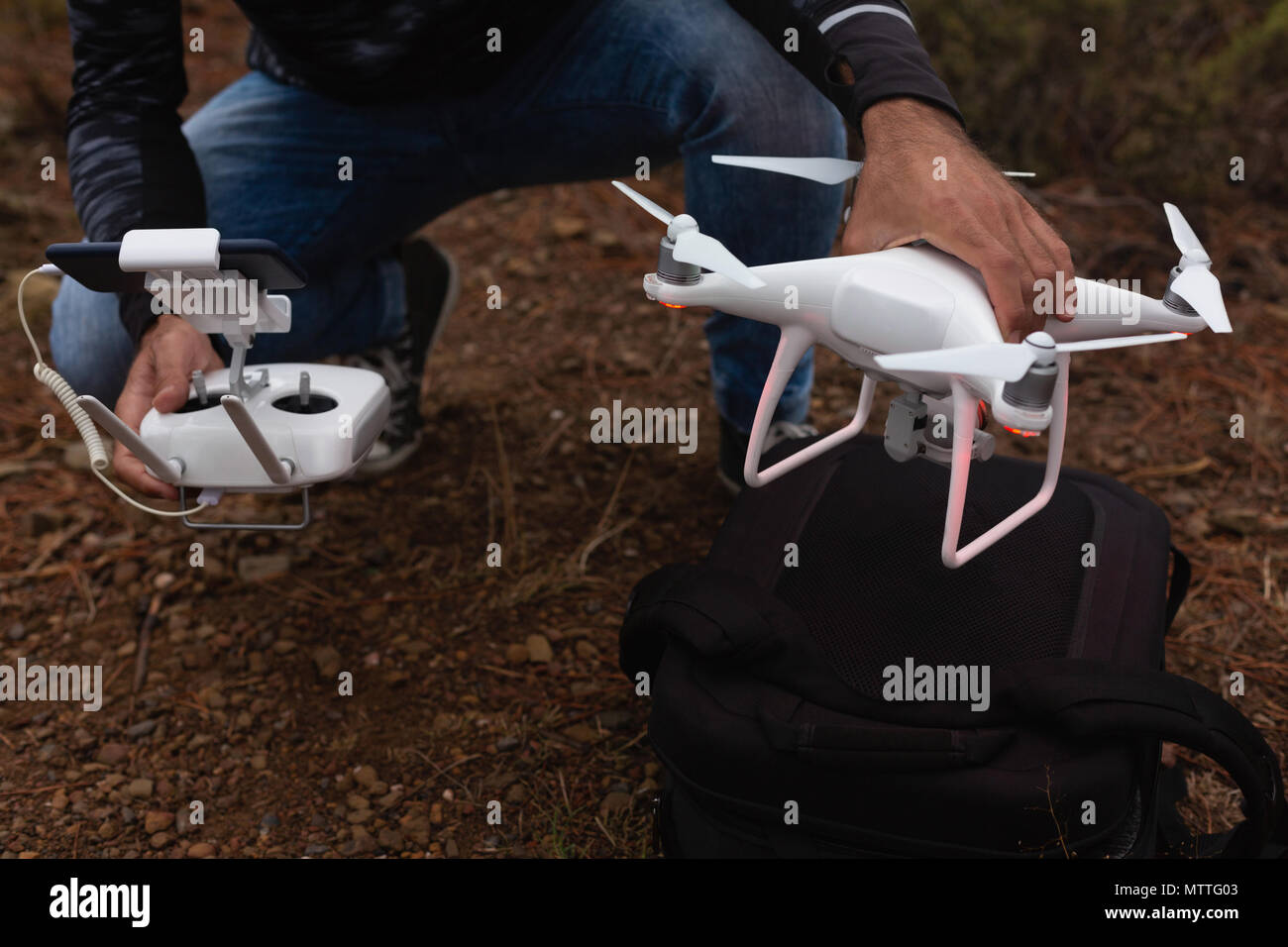 Man holding a flying drone and remote control Stock Photo - Alamy