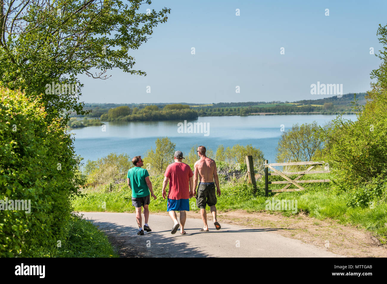 Three men walk hi-res stock photography and images - Alamy
