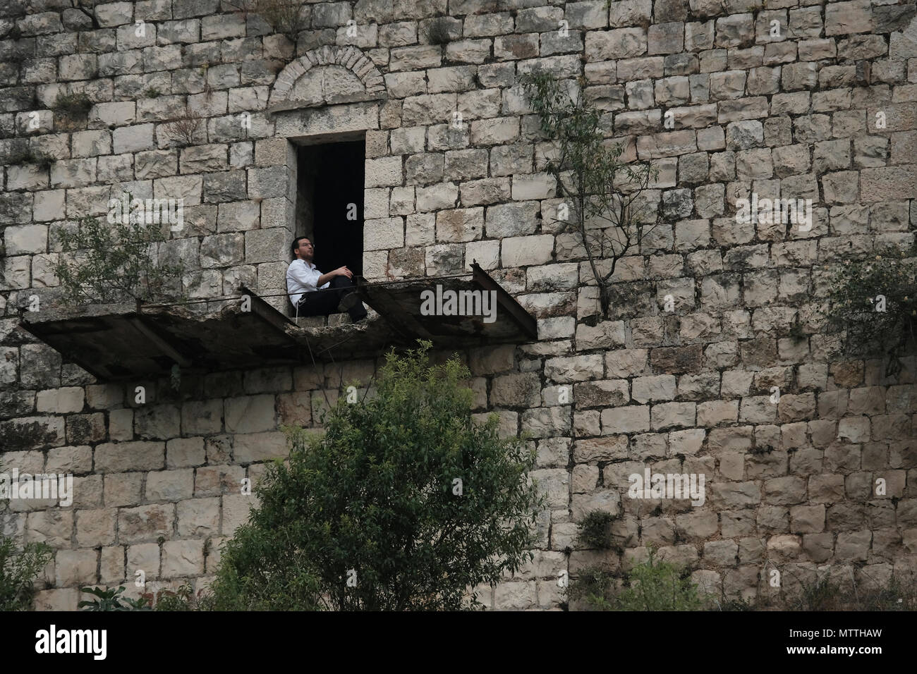 A religious Jew gazing from an abandoned house in the depopulated ...