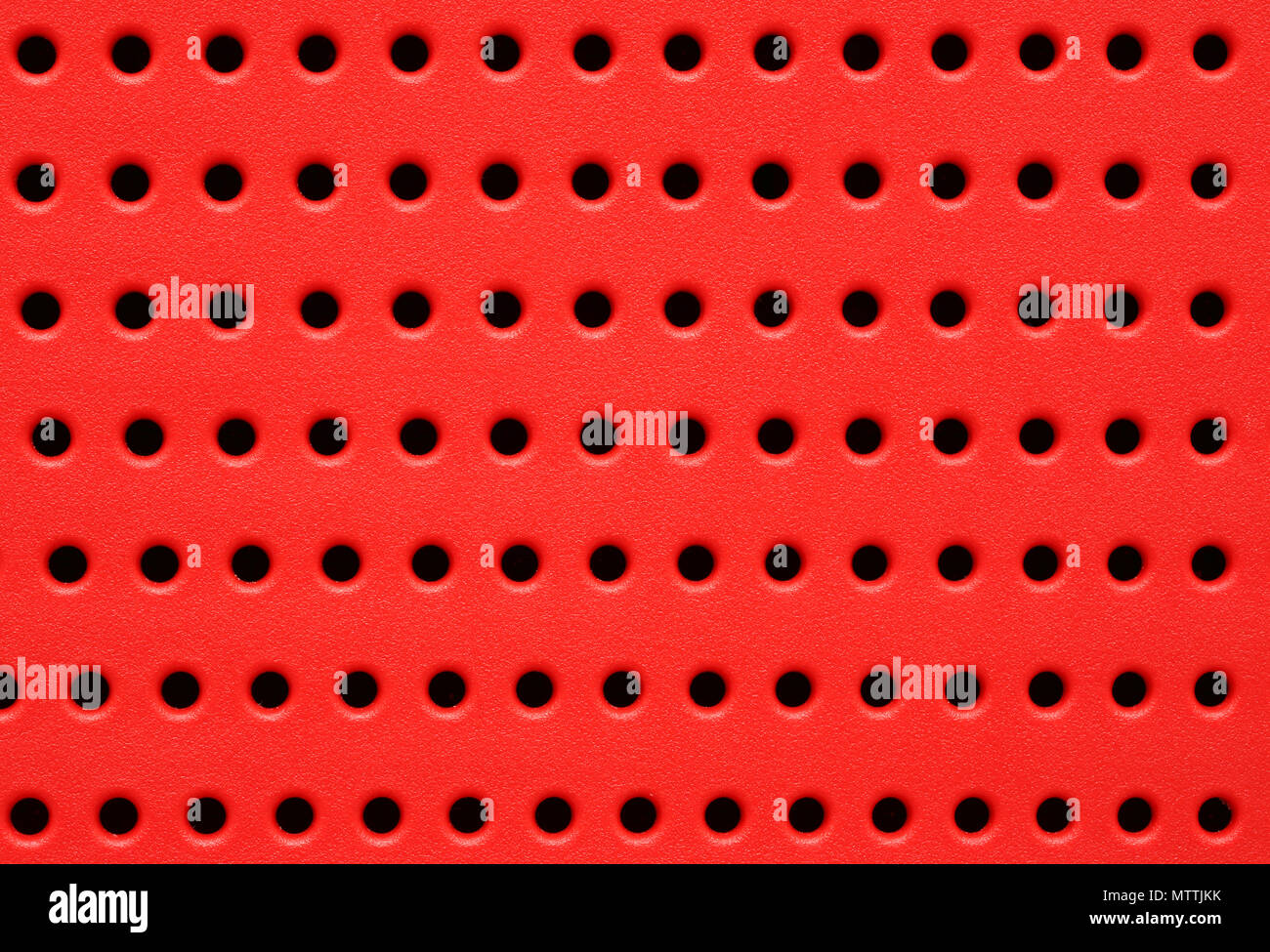 red perforated plastic background closeup Stock Photo - Alamy