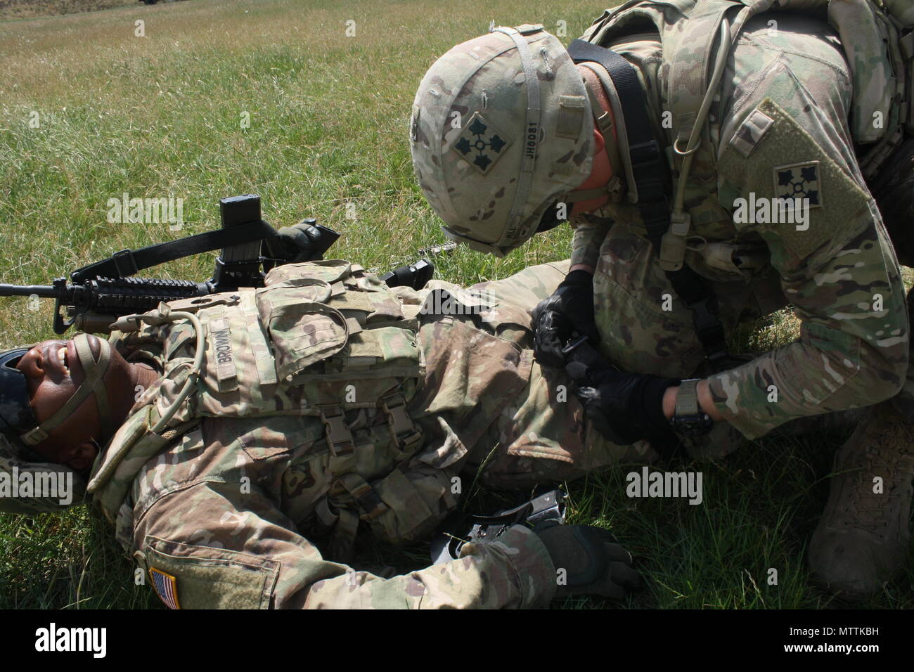 A Soldier simulates caring for a casualty during Advanced Rifle ...