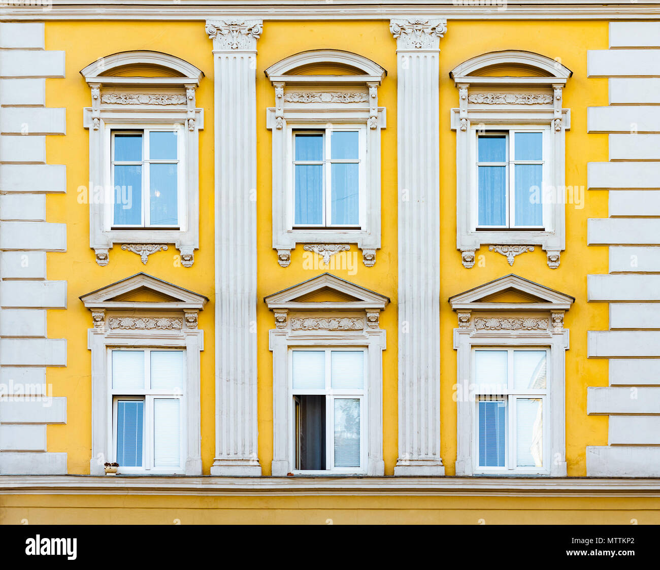 Facade of antique historical building. Windows with decorative stucco ...