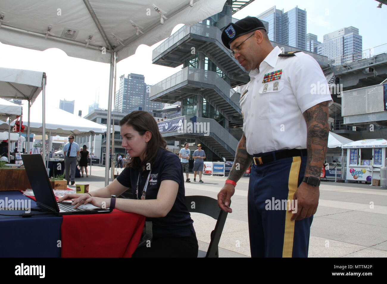 Master Sgt. David Foster (right) engaged a high volume of visitors at ...