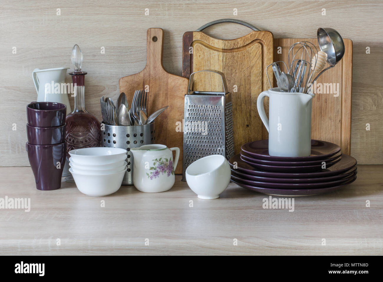 Crockery, tableware, utensils and other different stuff on wooden table ...