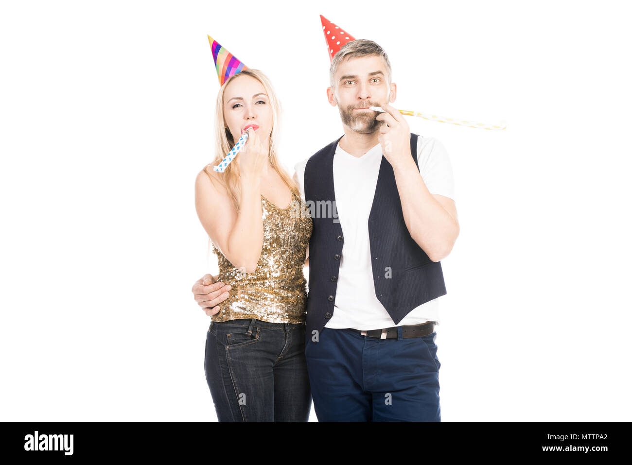 Young woman blowing party horn hi-res stock photography and images - Alamy