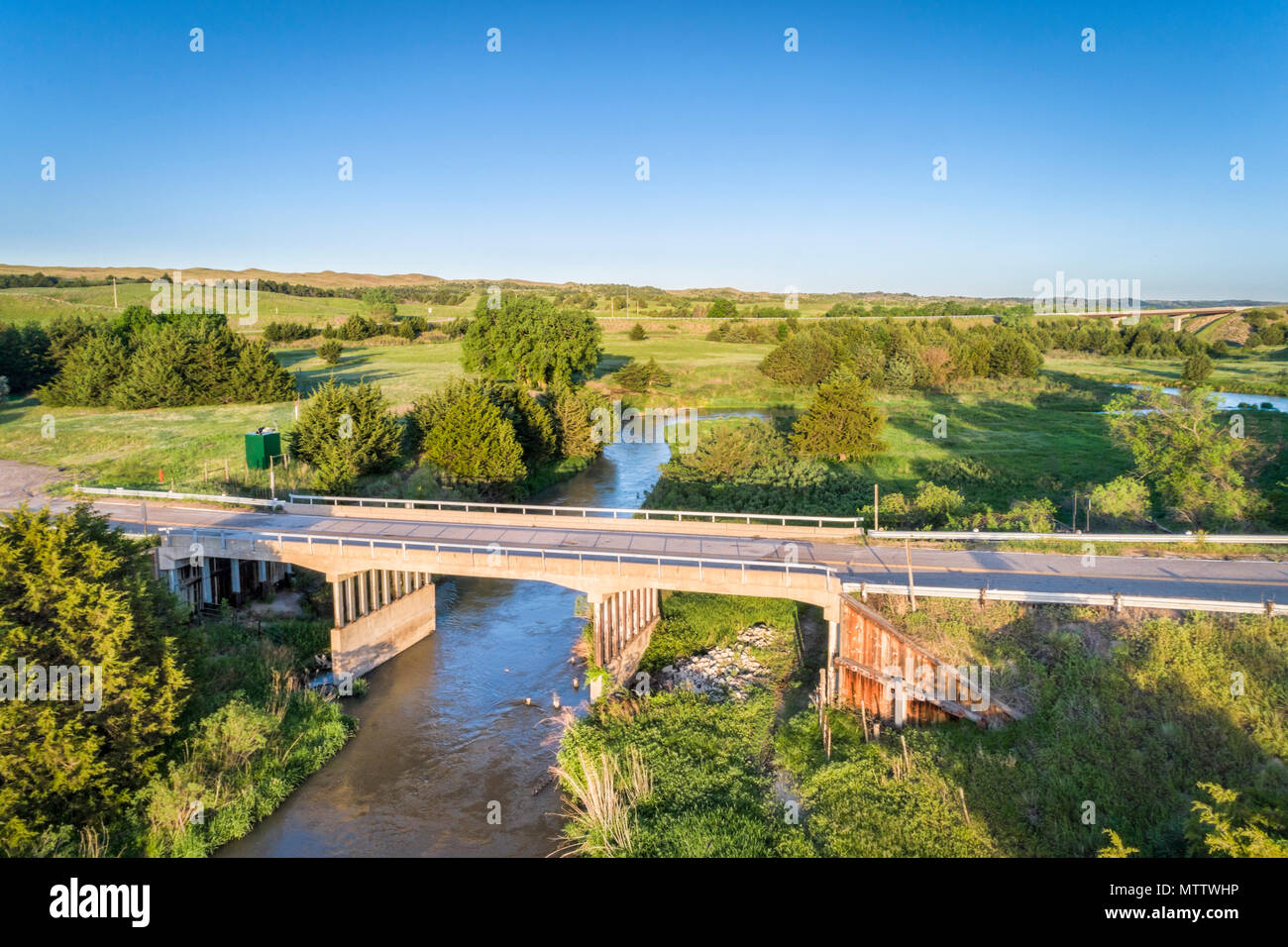 aerial view of a highway and bridge over the Dismal River in Nebraska ...