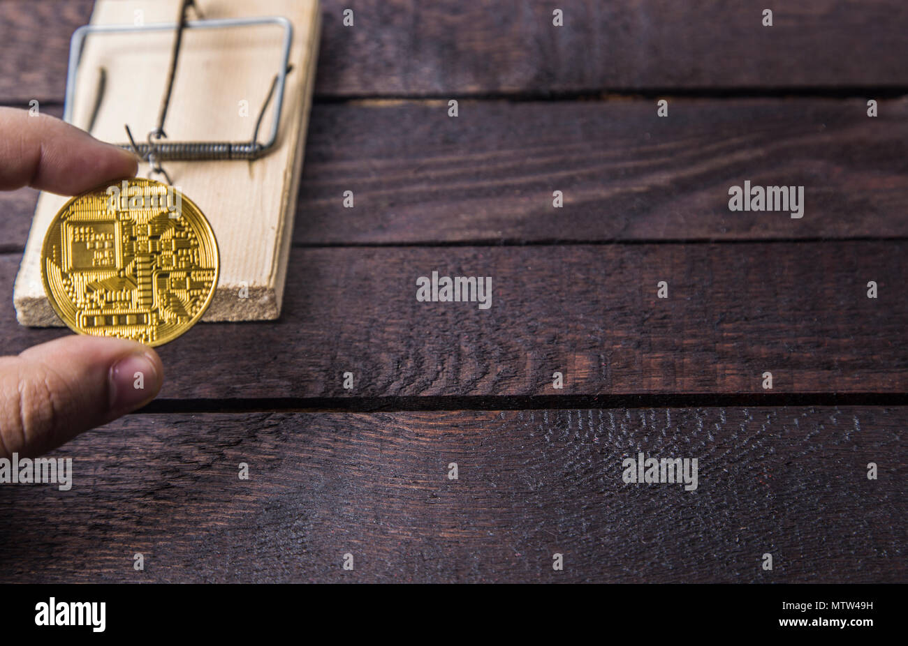 wooden mouse trap and man holds backside of bitcoin Stock Photo - Alamy