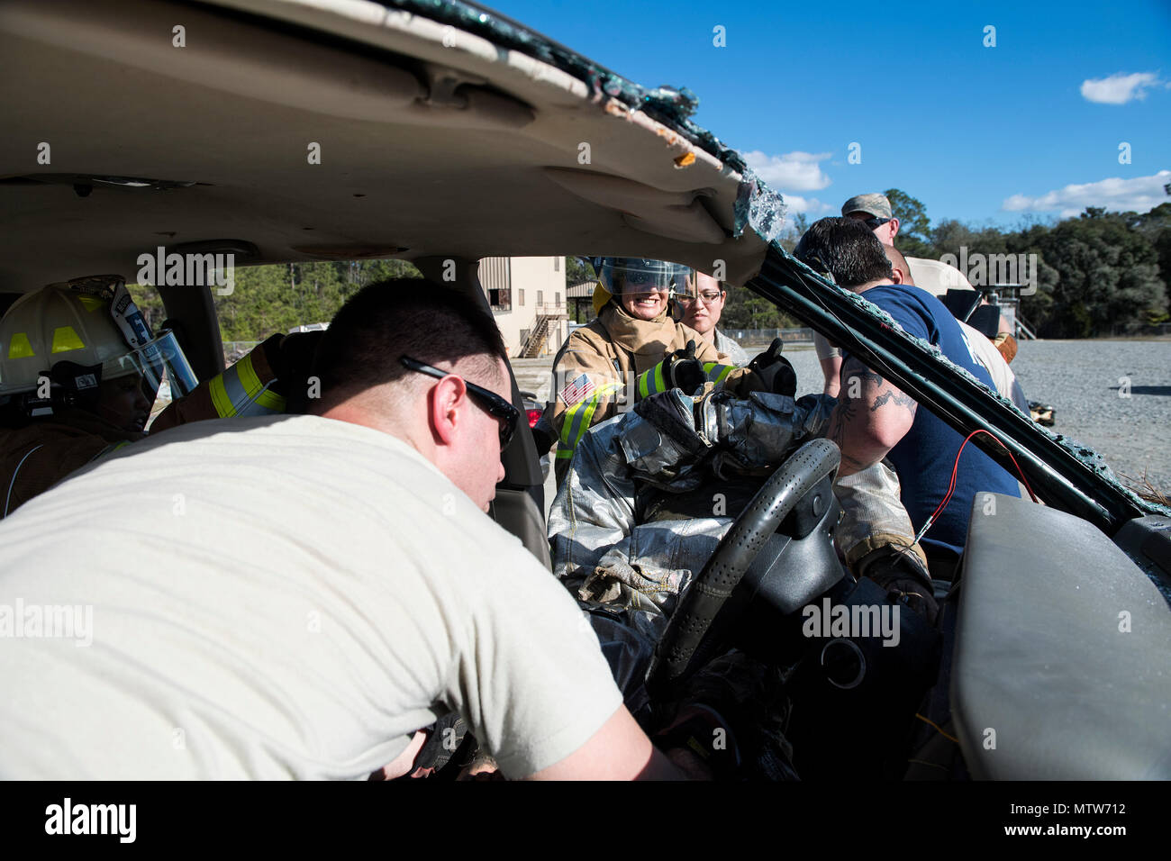 Participants work as a team to remove a simulated patient from a ...