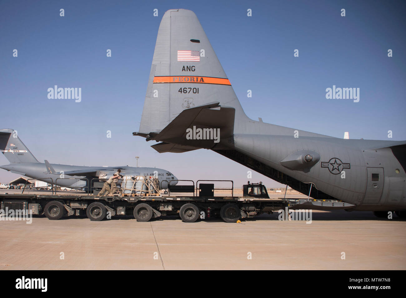 Aerial porters from the 870th Air Expeditionary Squadron push a pallet ...