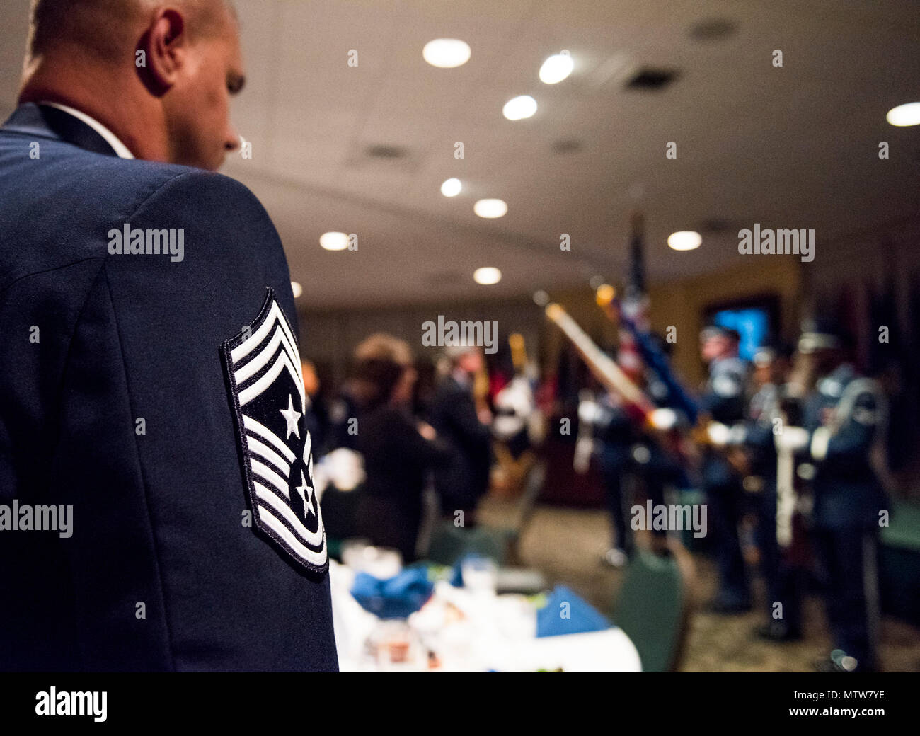 A command chief master sergeant stands during the presentation of the ...