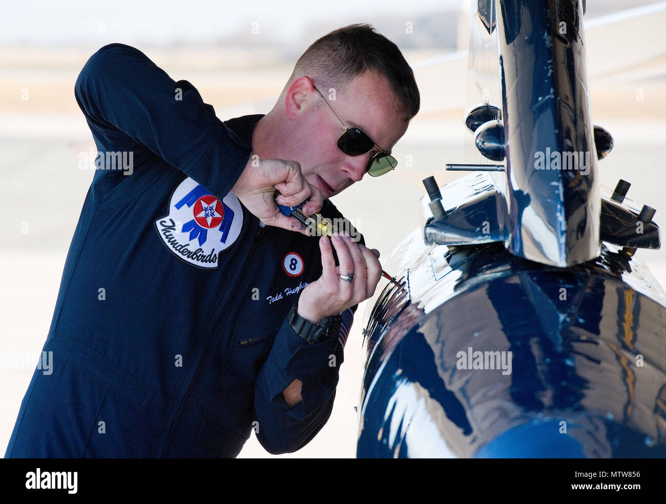 Staff Sgt. Todd Hughes, tactical aircraft maintainer, secures a panel ...