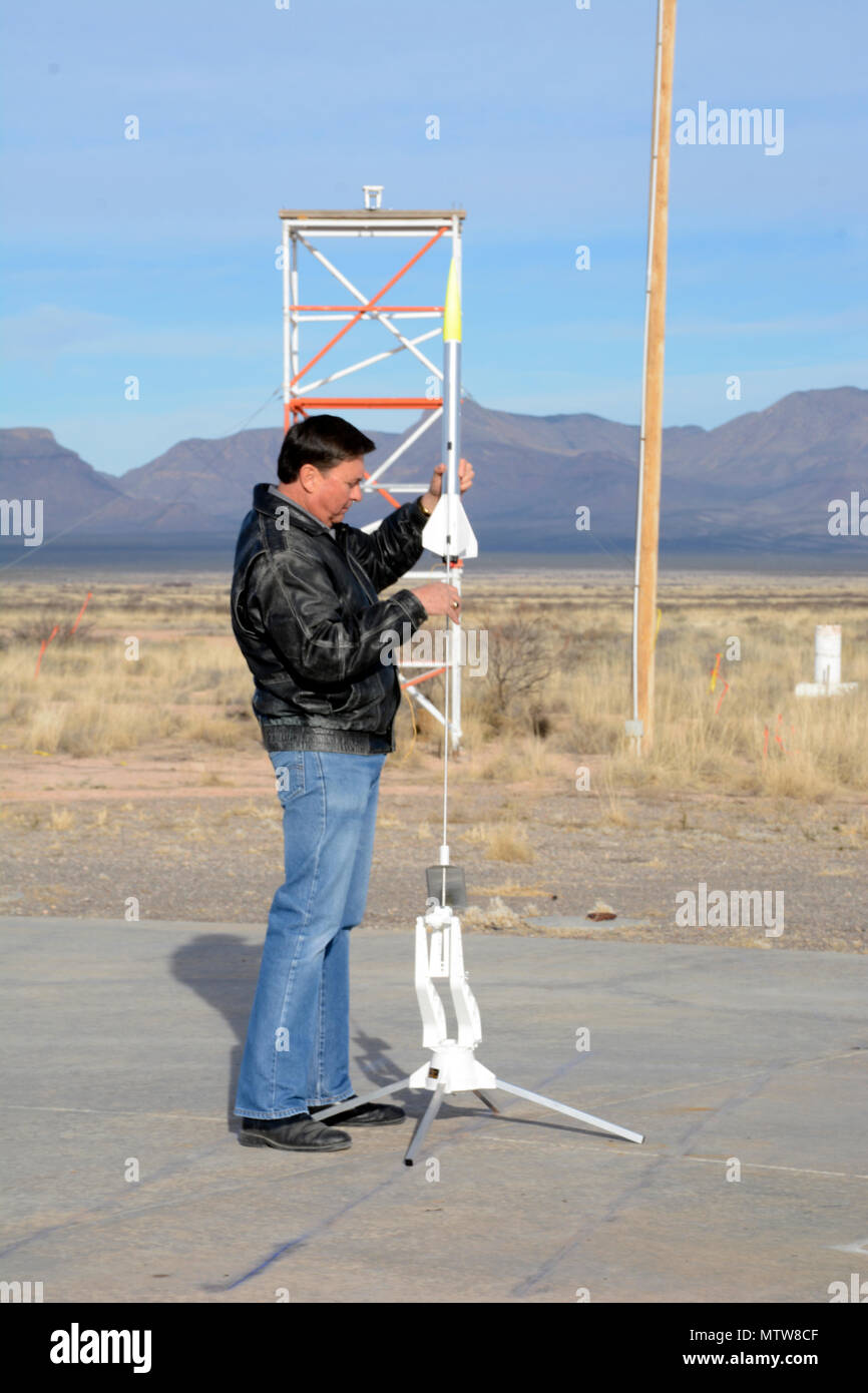 Jim Cutler, electronics engineer places the rocket on the launch pad out at West Center 50 ...
