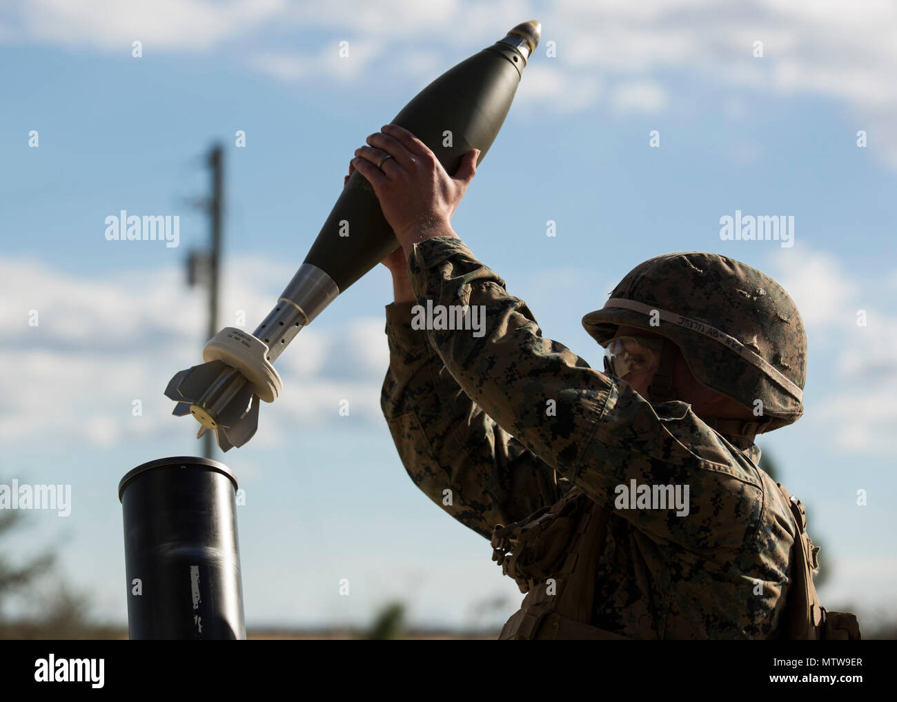 A Marine with Task Force Southwest prepares to load an M121 A1 120mm ...