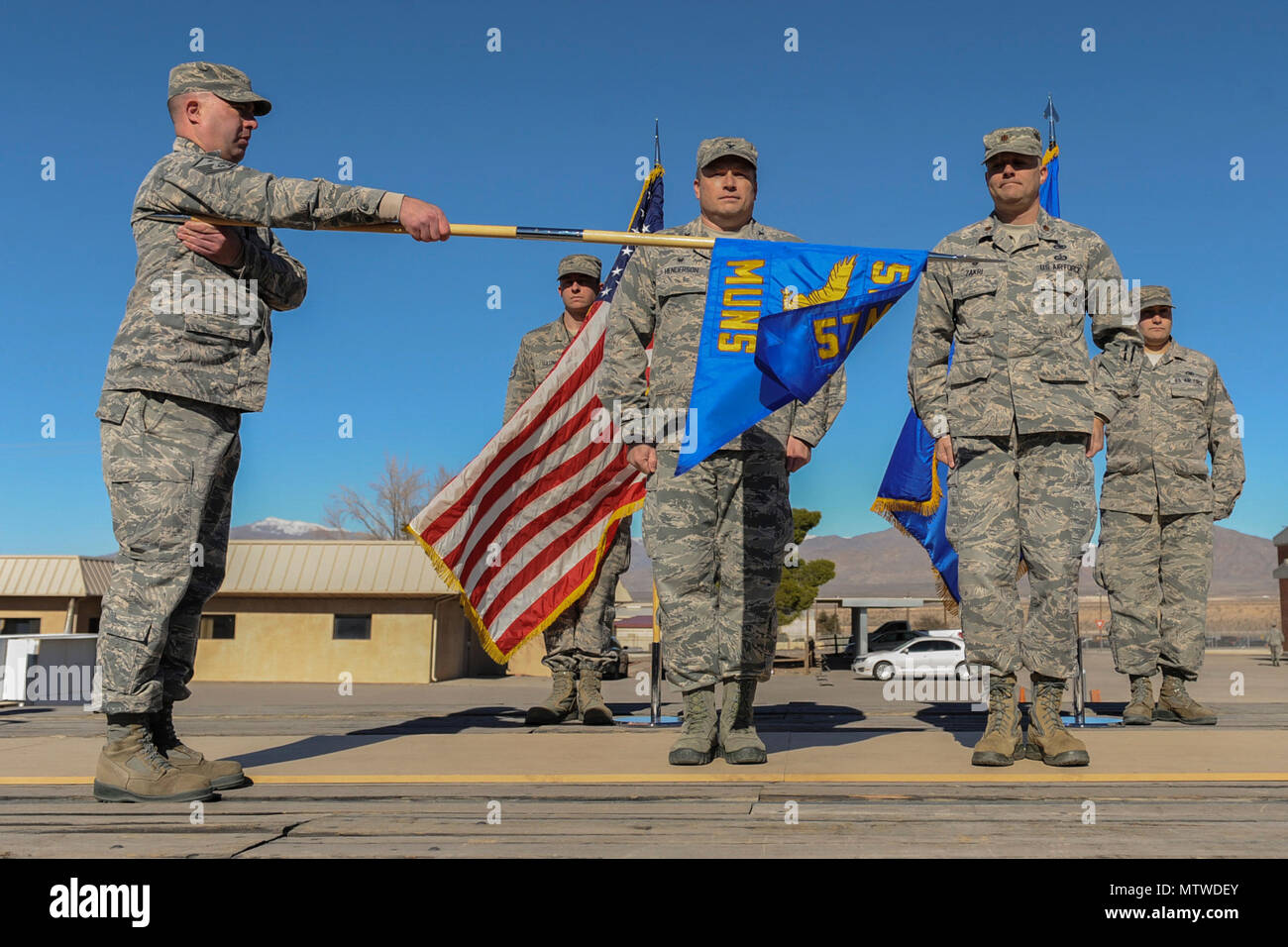 The 57th Munitions Squadron guidon is displayed after its unfurling ...
