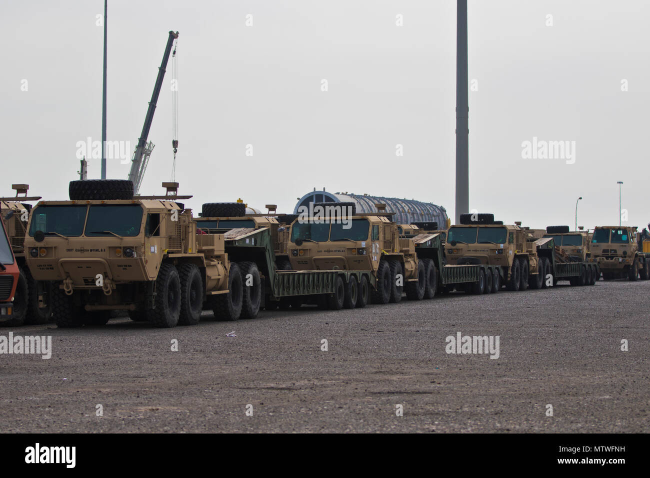 U.S. Army Heavy Expanded Mobility Tractical Trucks are linned up to be ...