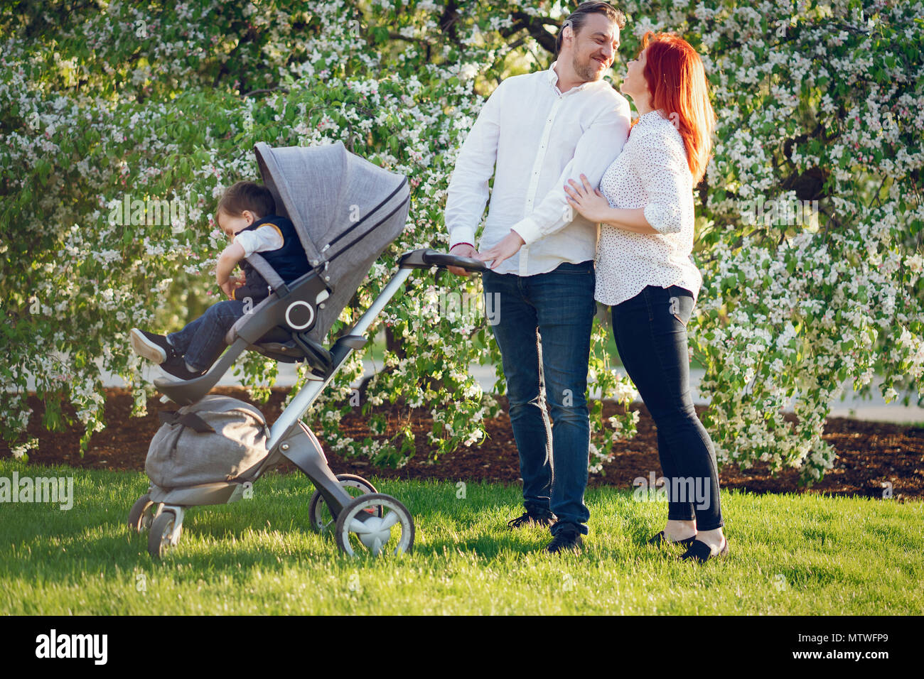 Happy family in spring park hi-res stock photography and images - Alamy
