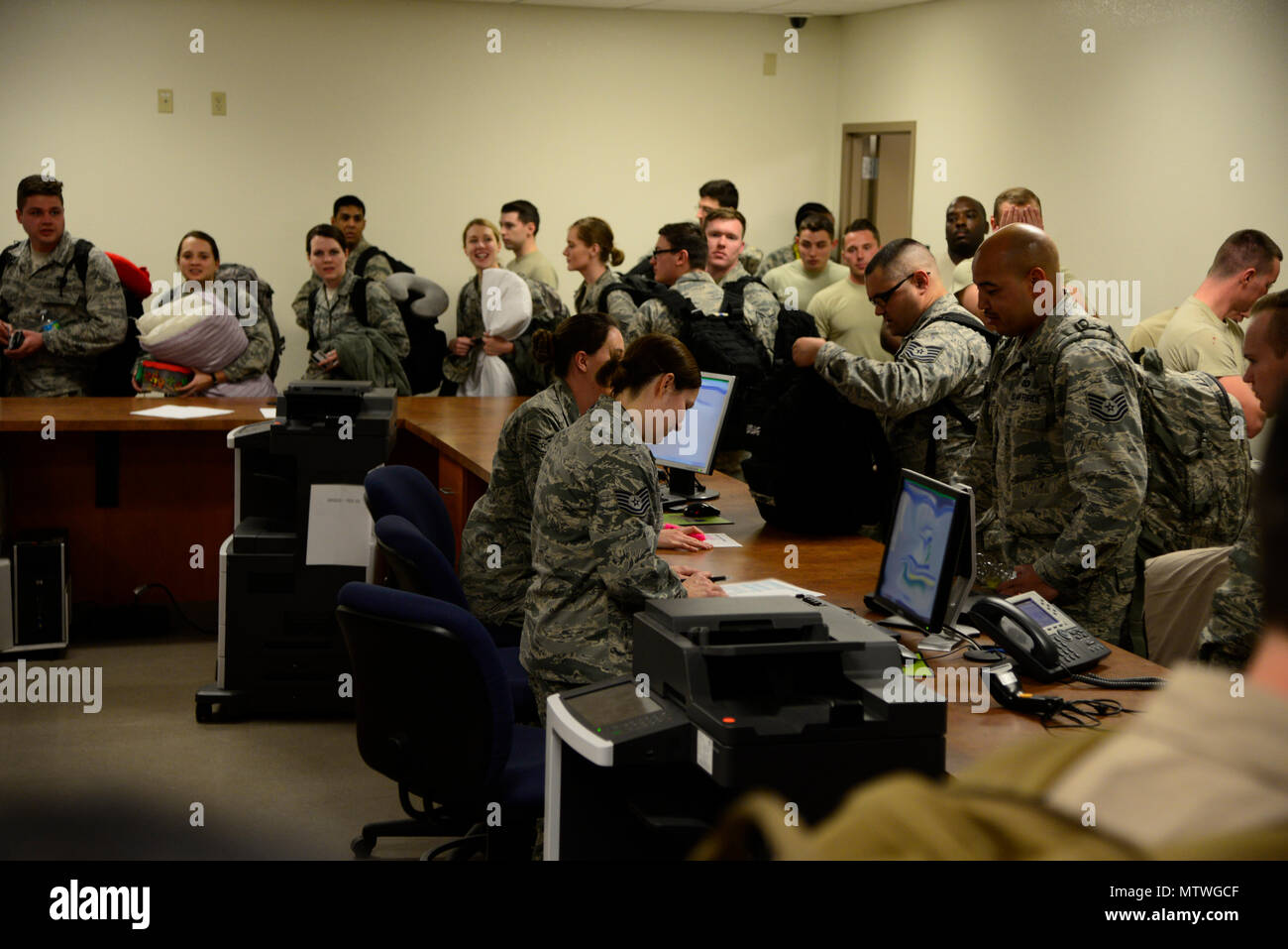 U.S. Airmen process through the personnel deployment function before ...