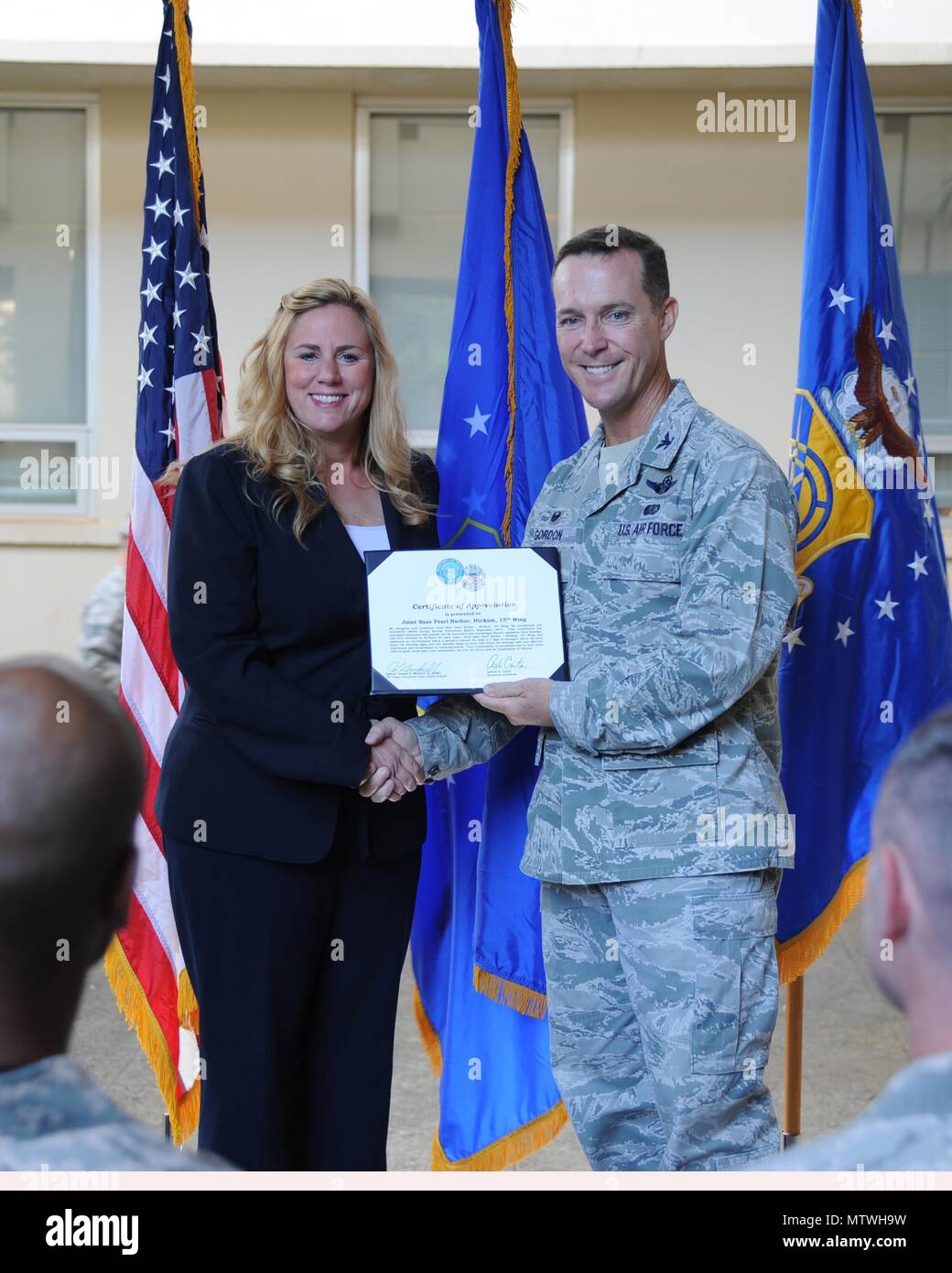 Col. Kevin Gordon, 15th Wing commander, accepts a certificate of ...