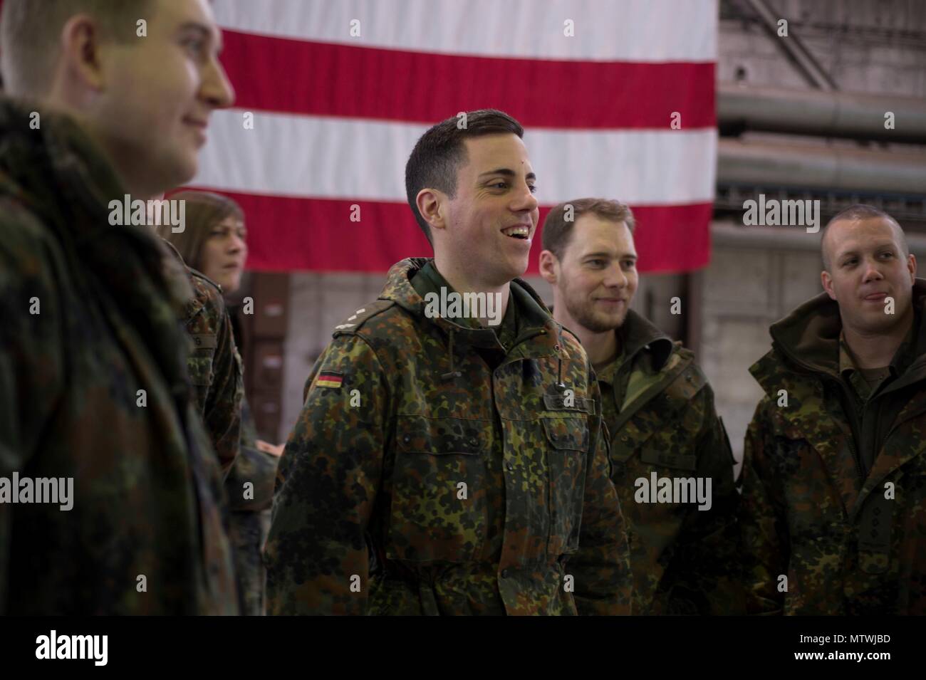 German air force members are briefed about the engine structure of an F ...
