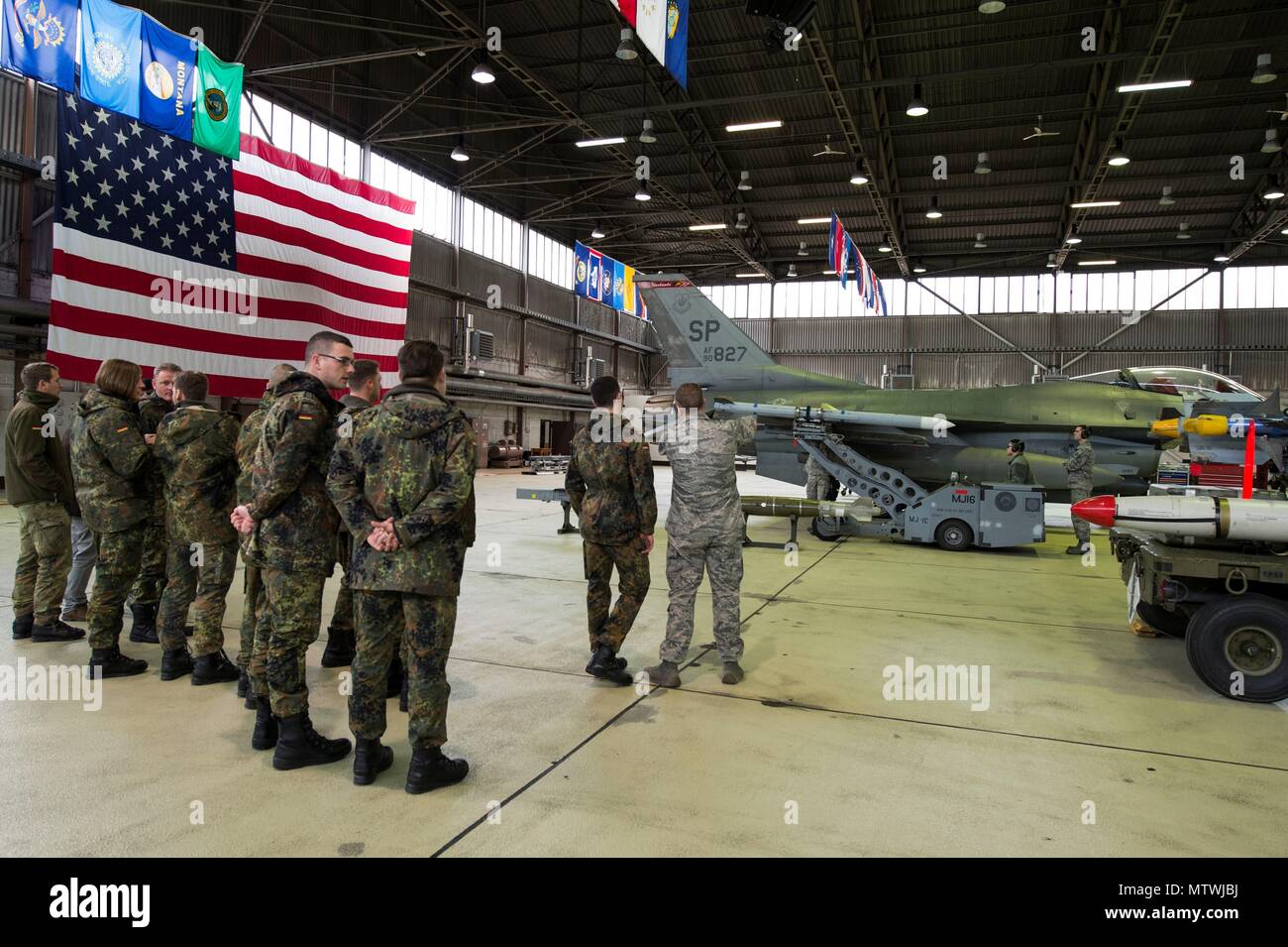 German air force members view an F-16 Fighting Falcon in Hangar 1 ...