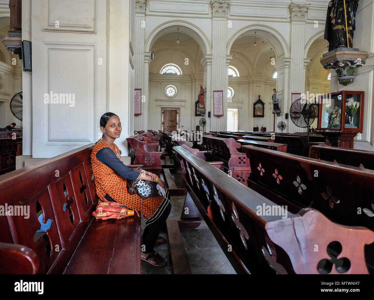 Galle, Sri Lanka - Sep 9, 2015. A young woman praying at the church in ...