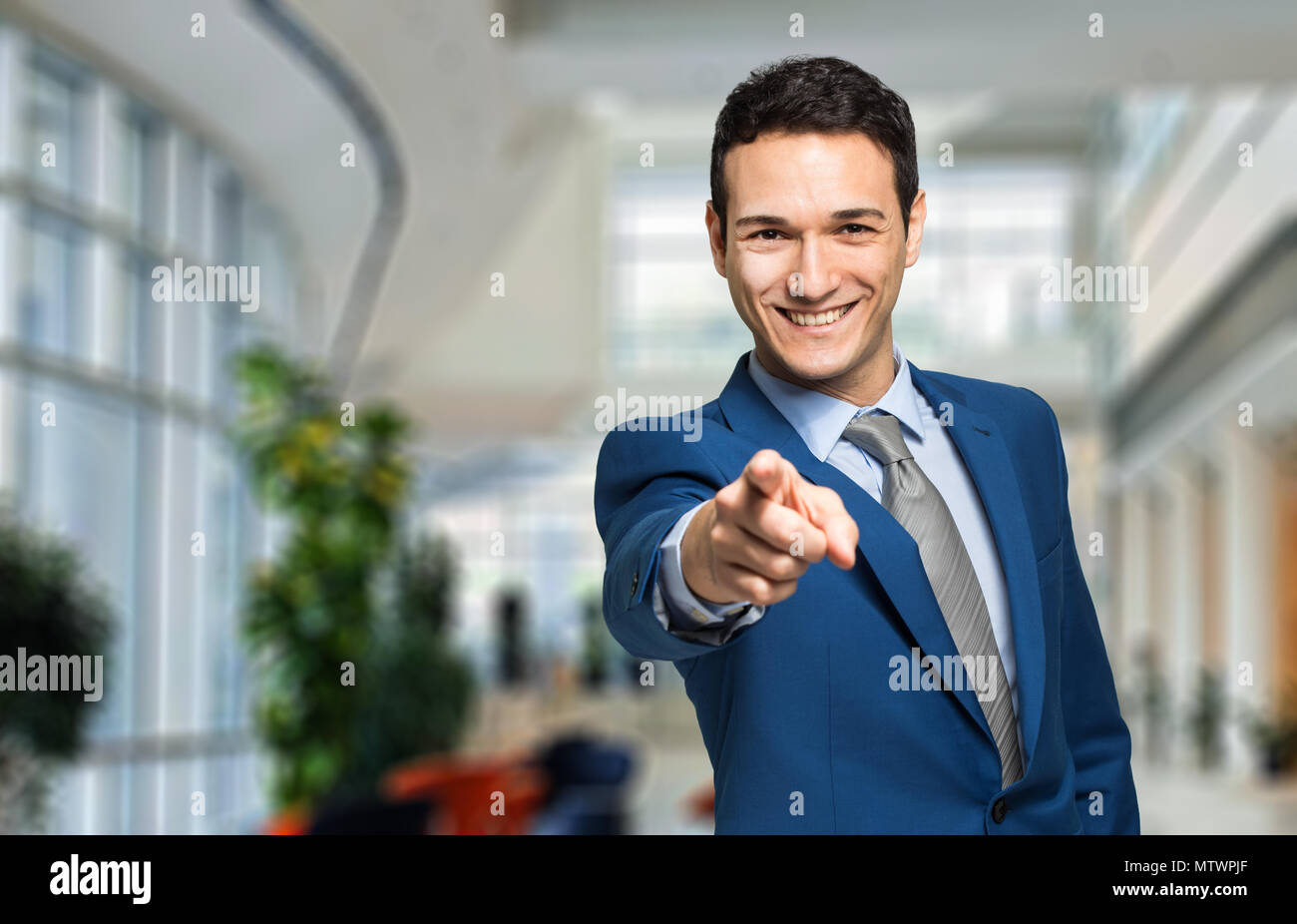 Portrait of young businessman pointing finger at viewer Stock Photo - Alamy