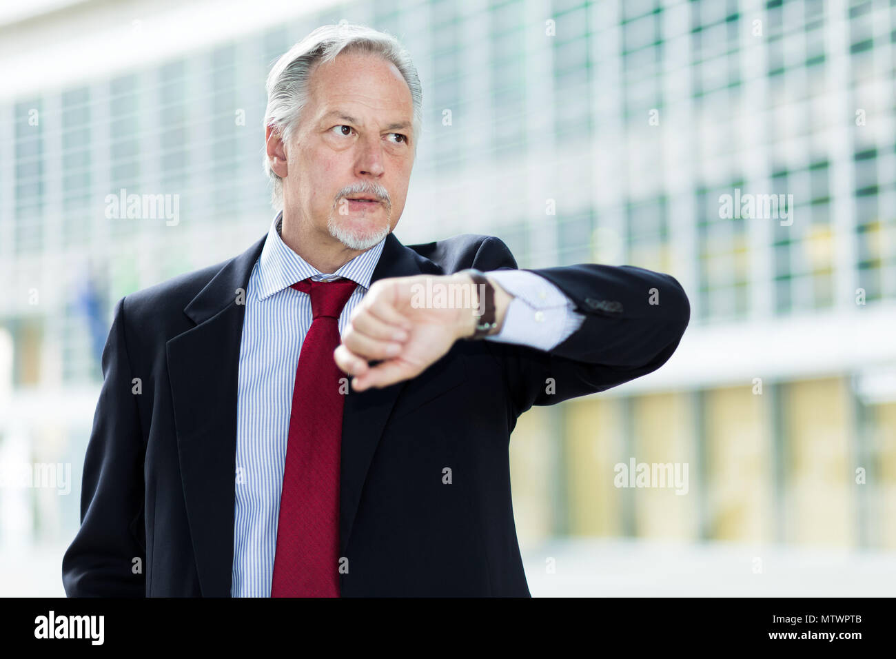 Business man watching the time Stock Photo - Alamy
