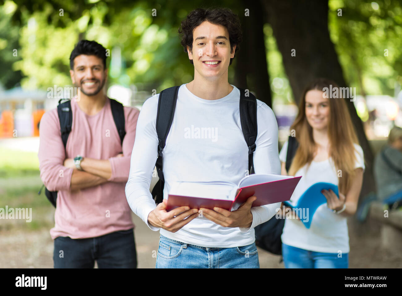 Happy students outdoor smiling Stock Photo - Alamy