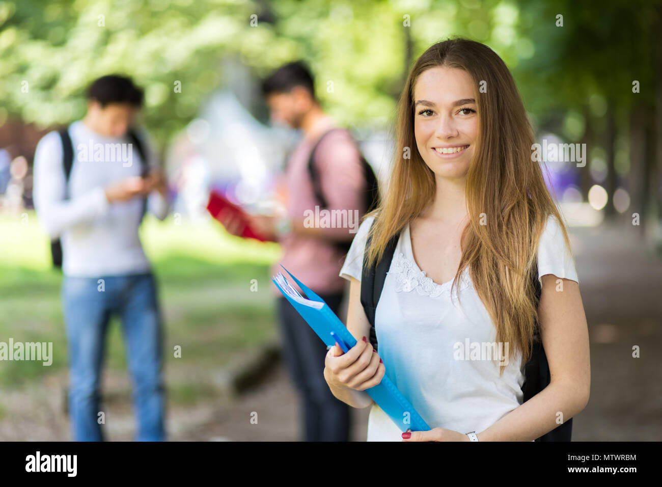 Happy students outdoor smiling Stock Photo - Alamy
