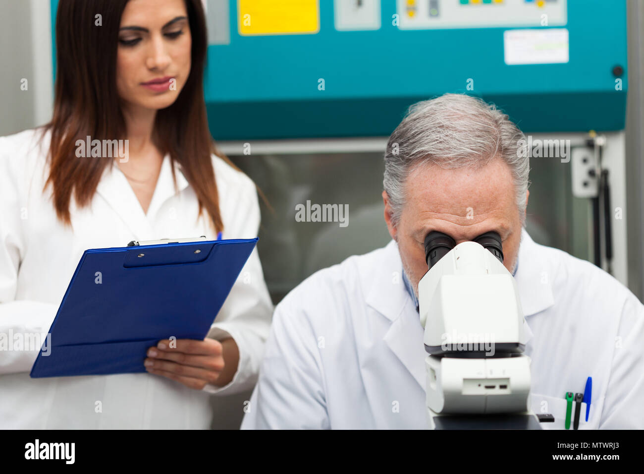 Senior scientist using a microscope in his laboratory Stock Photo - Alamy