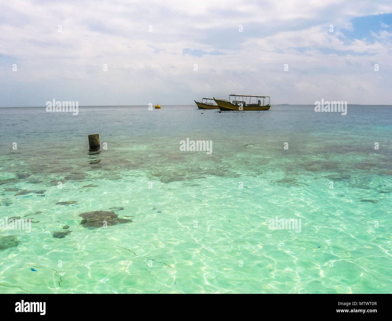 Maldives, Indian Ocean. Turquoise water of the lagoon. Rocks and coral ...