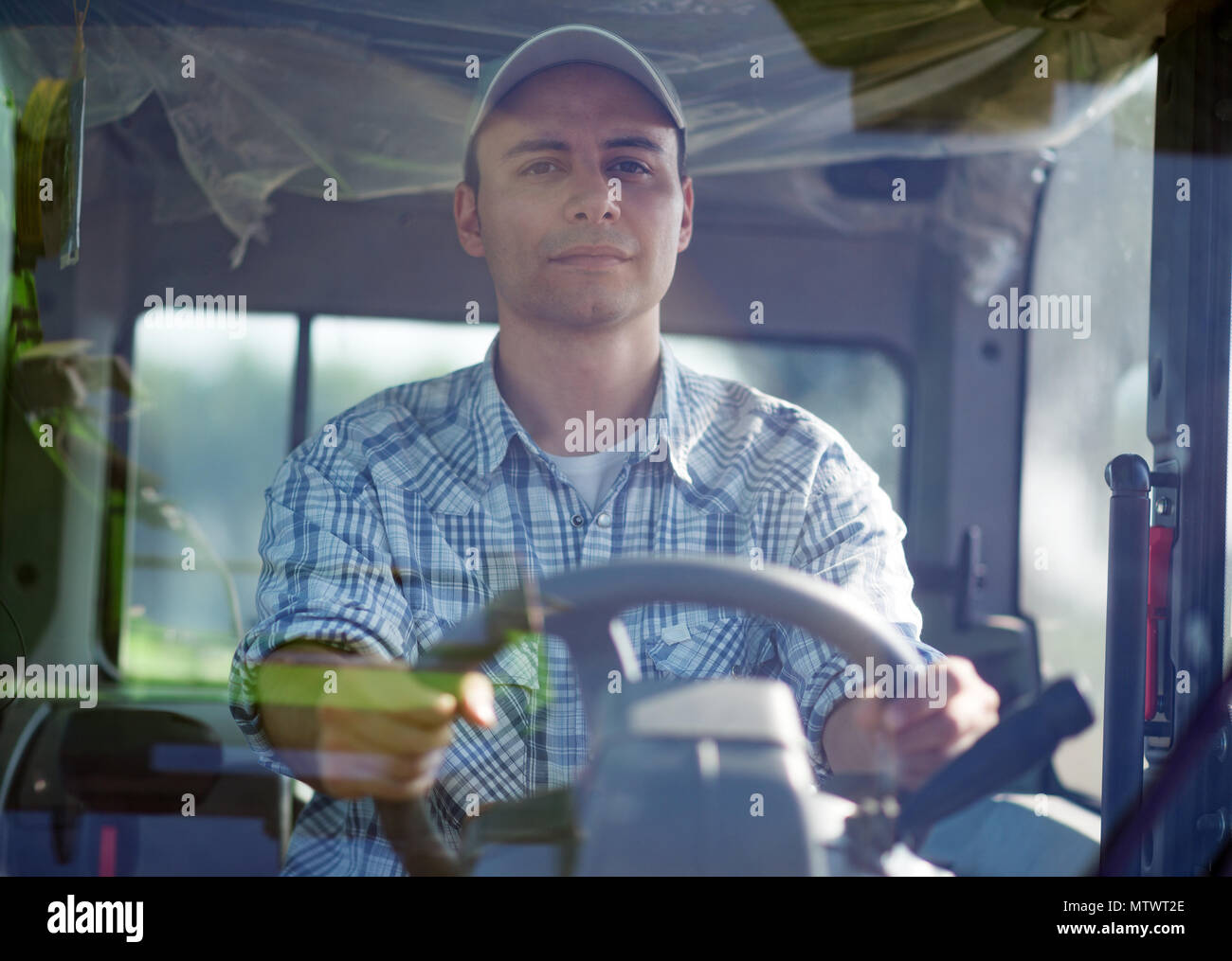 Farmer driving his tractor hi-res stock photography and images - Alamy