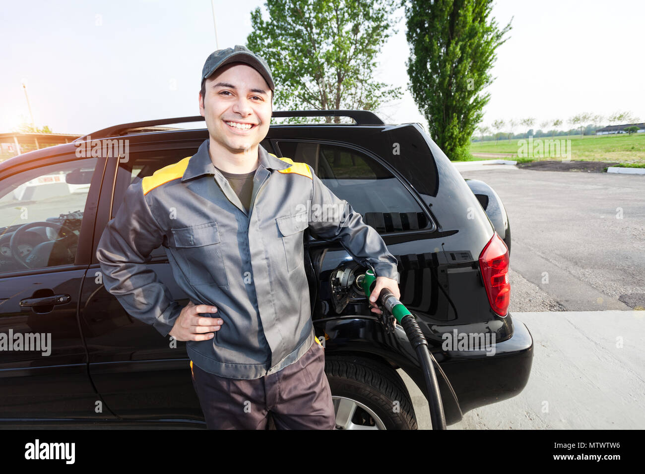 Smiling worker at the gas station Stock Photo - Alamy