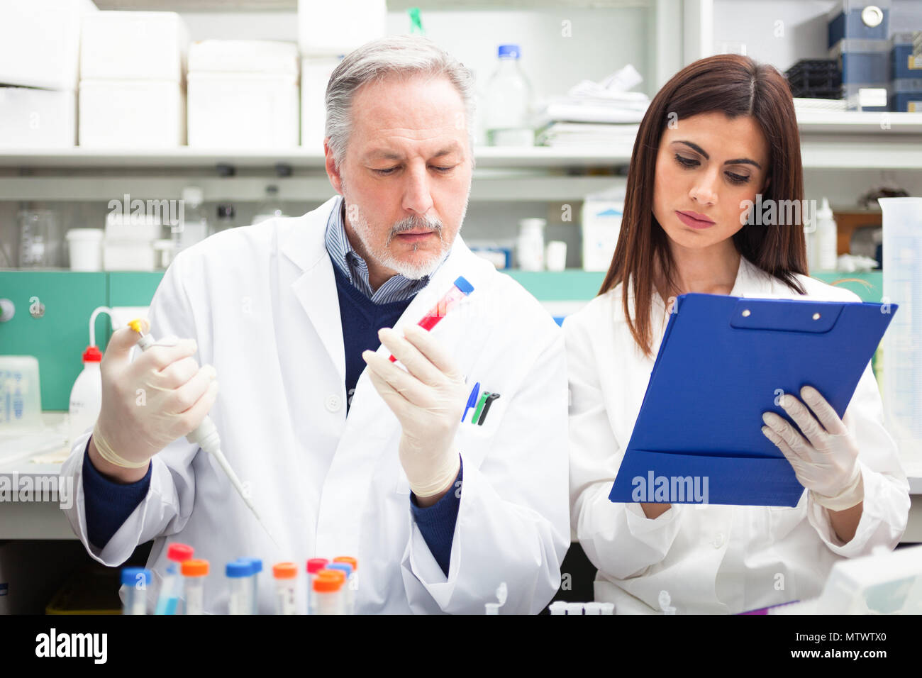 Scientists at work in a laboratory Stock Photo - Alamy