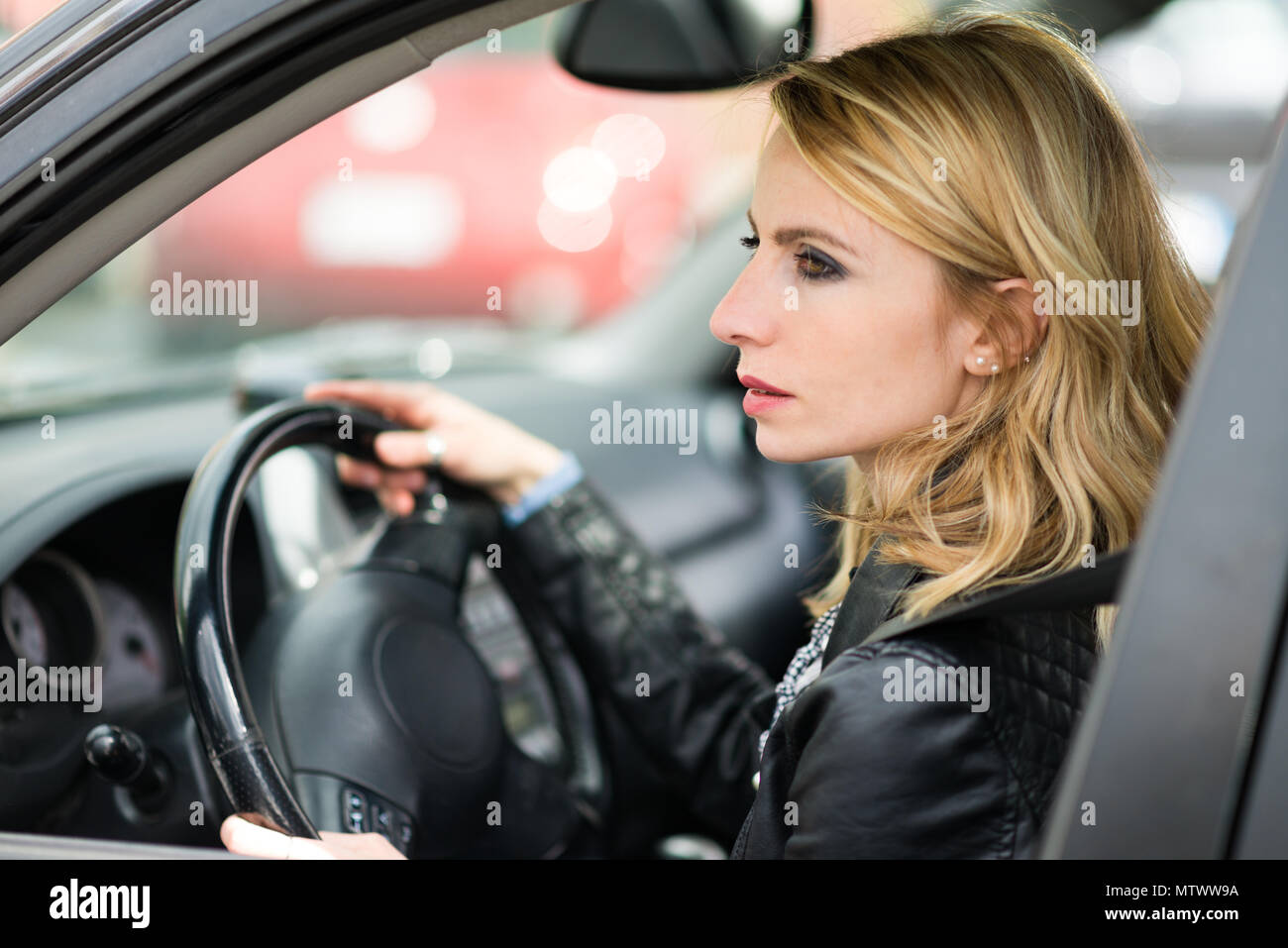 Blonde woman driving her car Stock Photo - Alamy