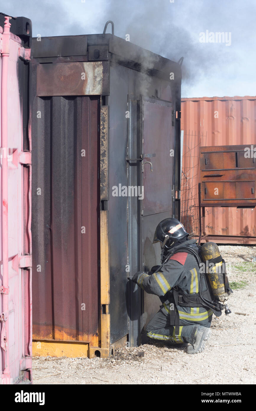Firefighter putting out fire training station extinguisher backdraft ...