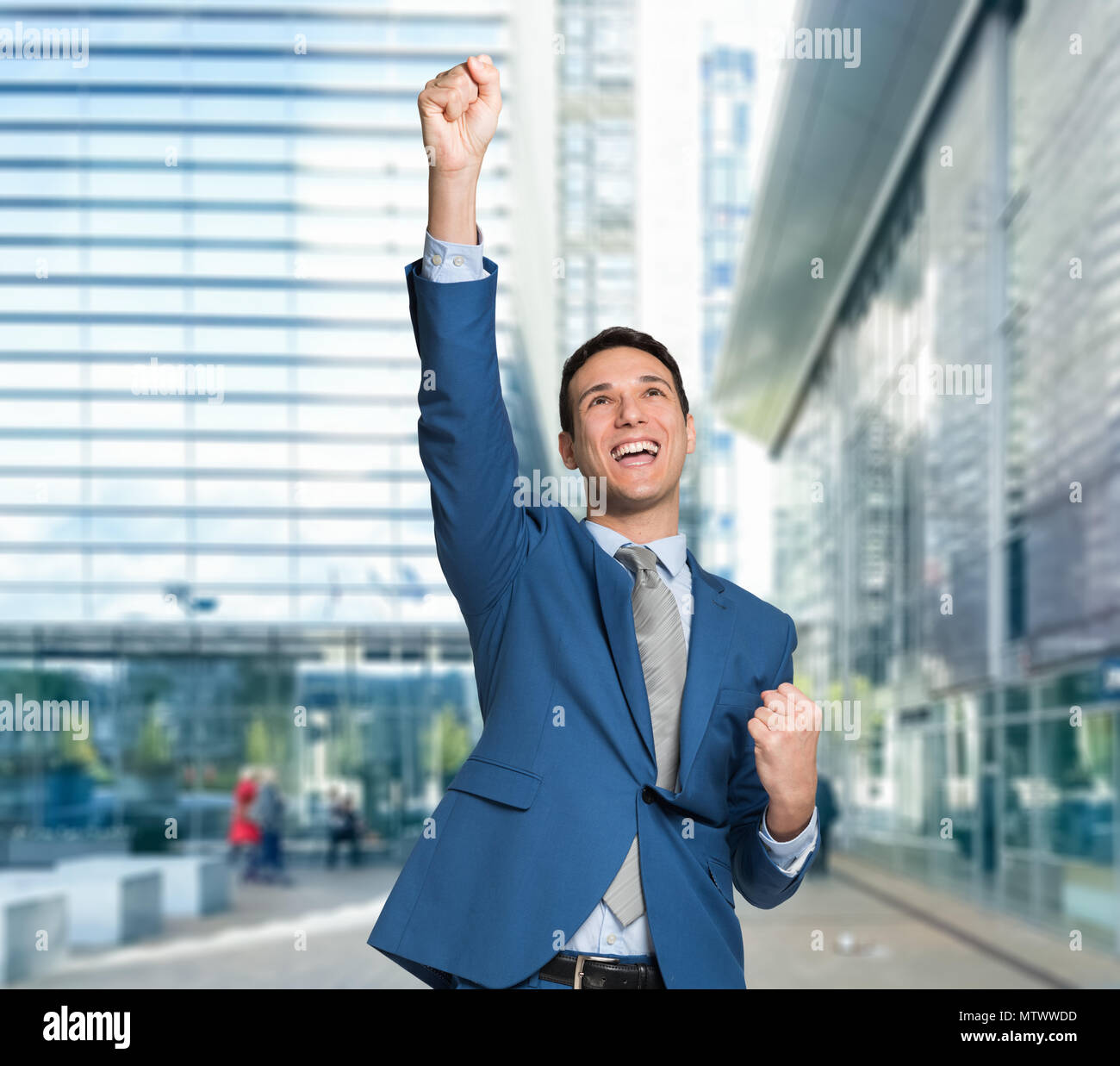 Very happy businessman in front of his office Stock Photo - Alamy