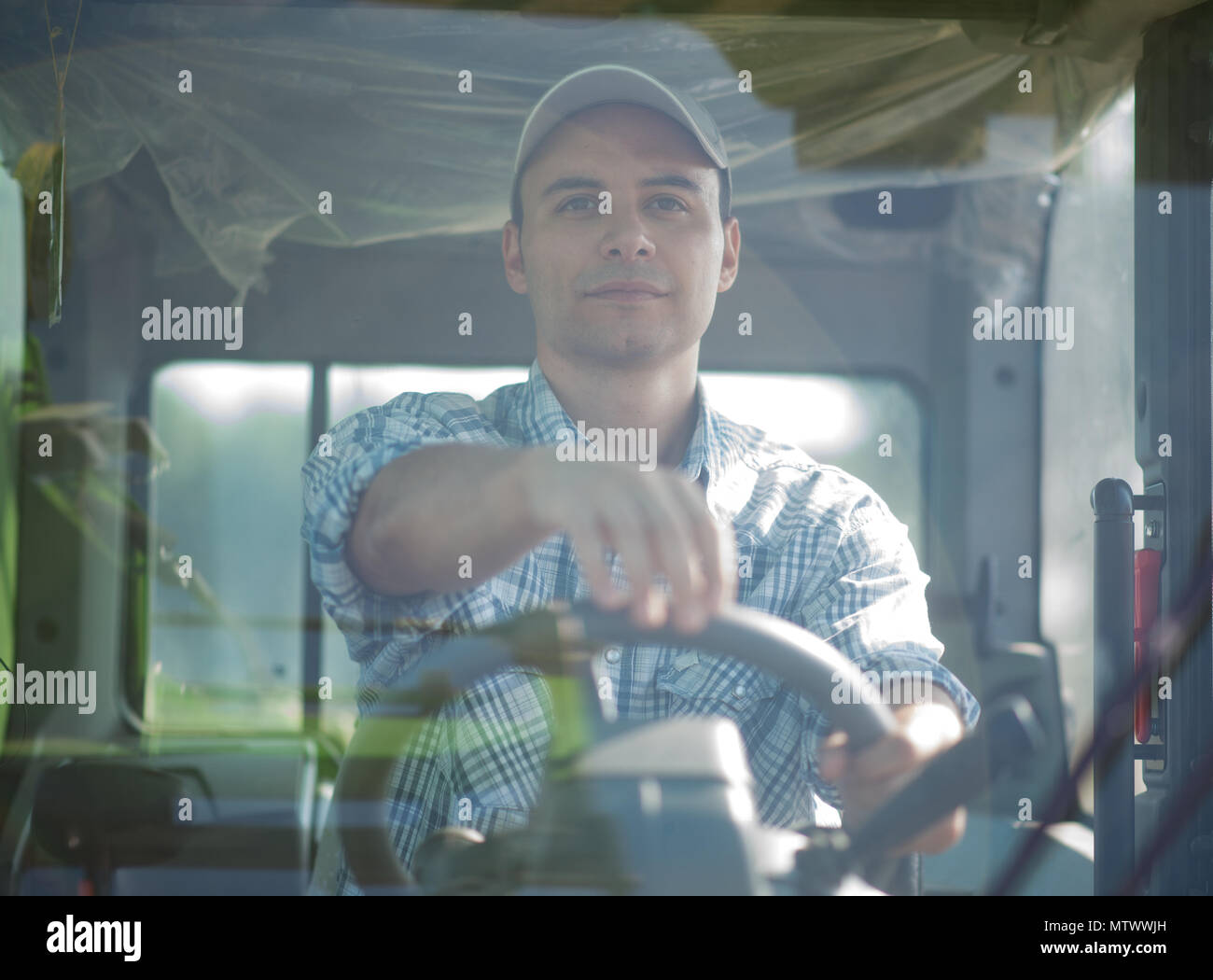 Farmer driving his tractor hi-res stock photography and images - Alamy
