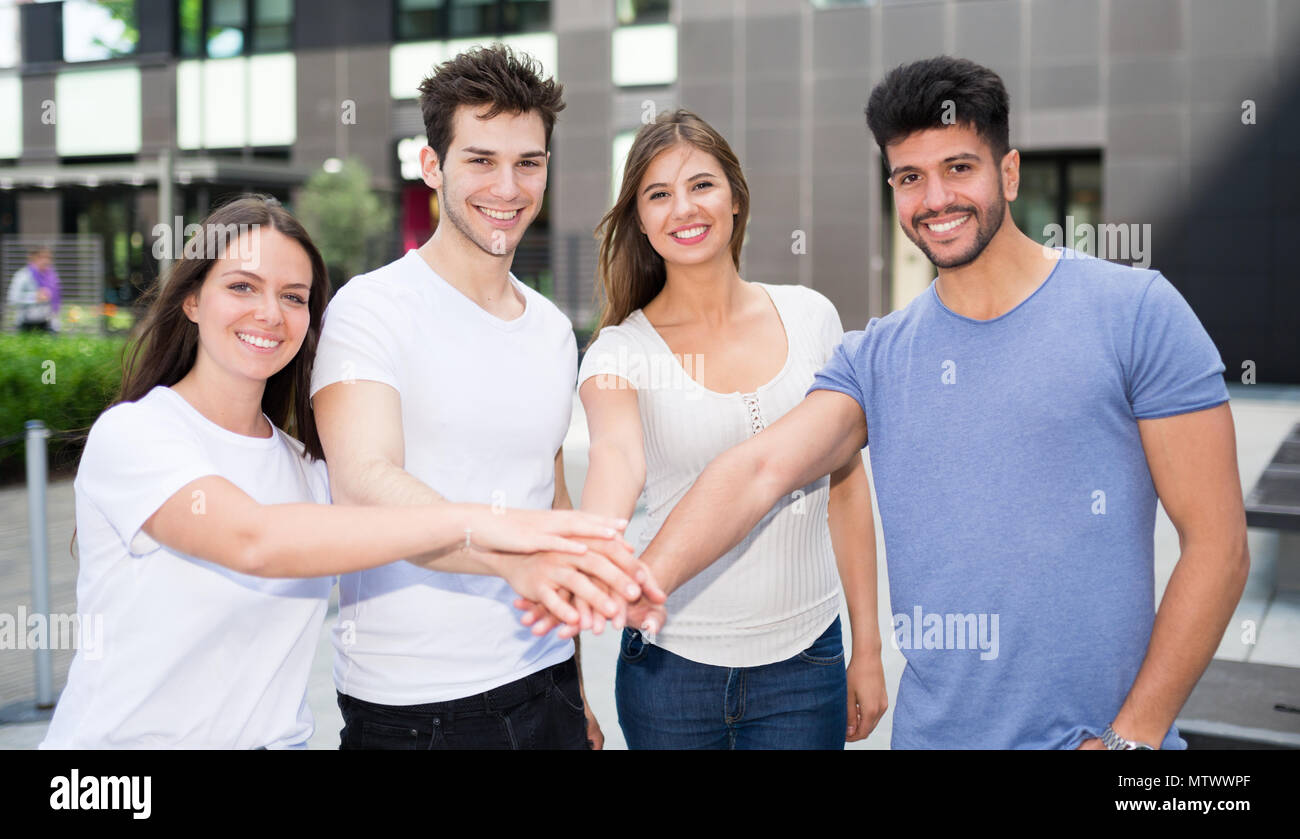 Group friends putting hands together hi-res stock photography and ...