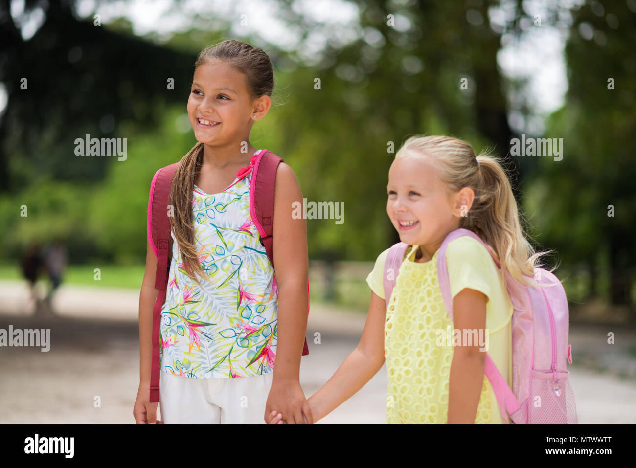 Happy girls going to school Stock Photo - Alamy