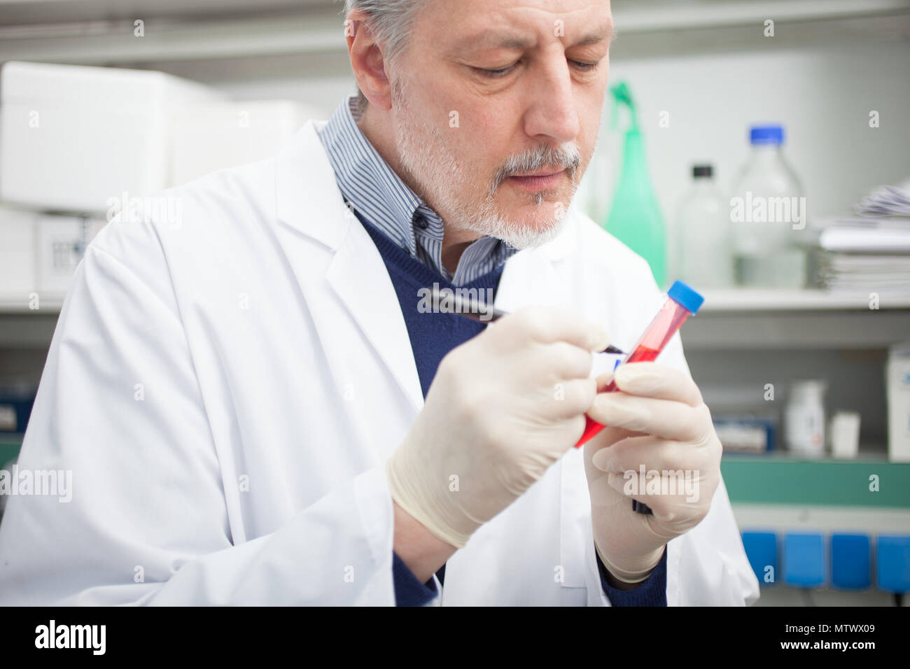 Lab worker writing on a test tube Stock Photo - Alamy