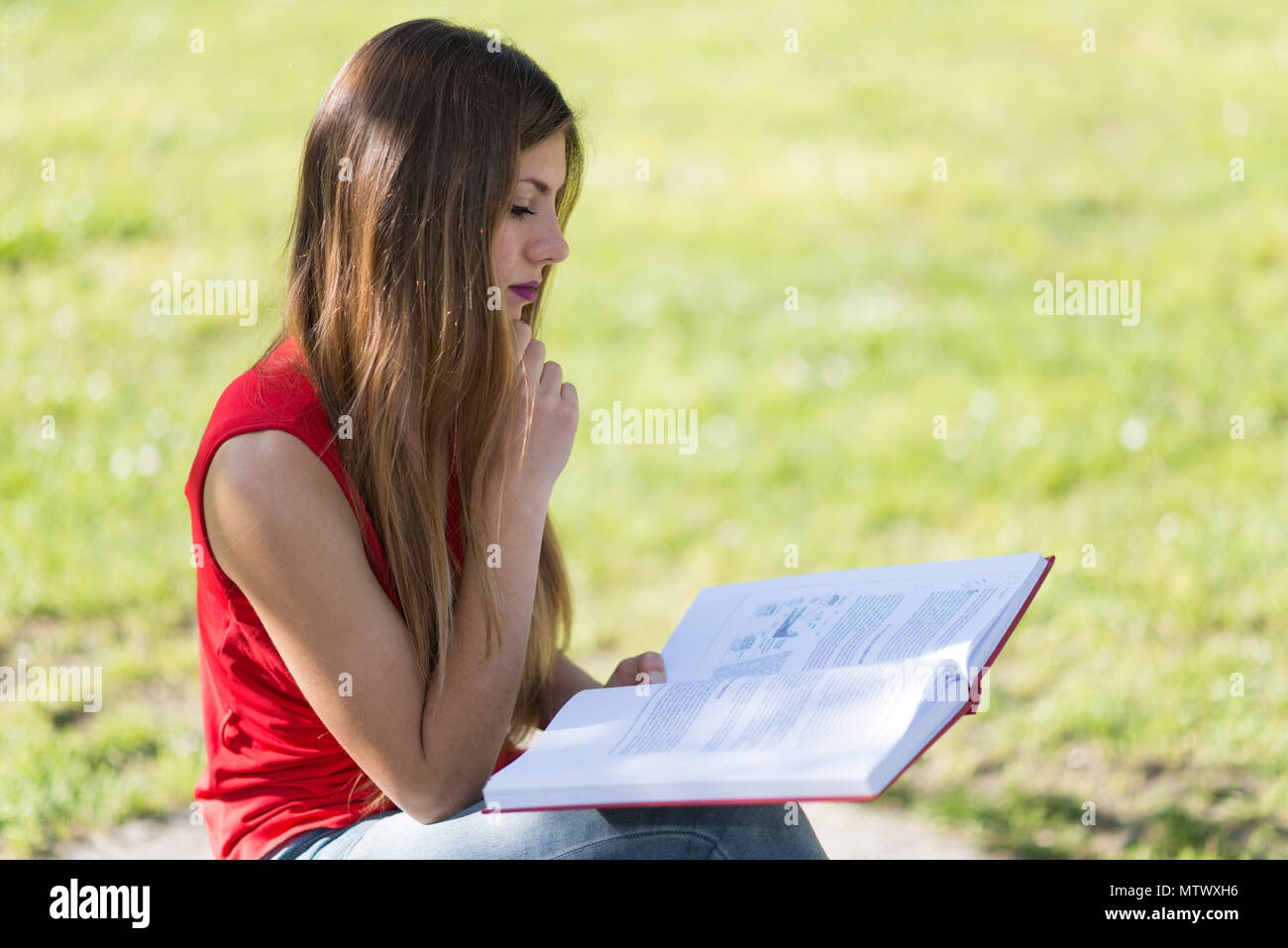 Woman reading a book outdoor Stock Photo - Alamy