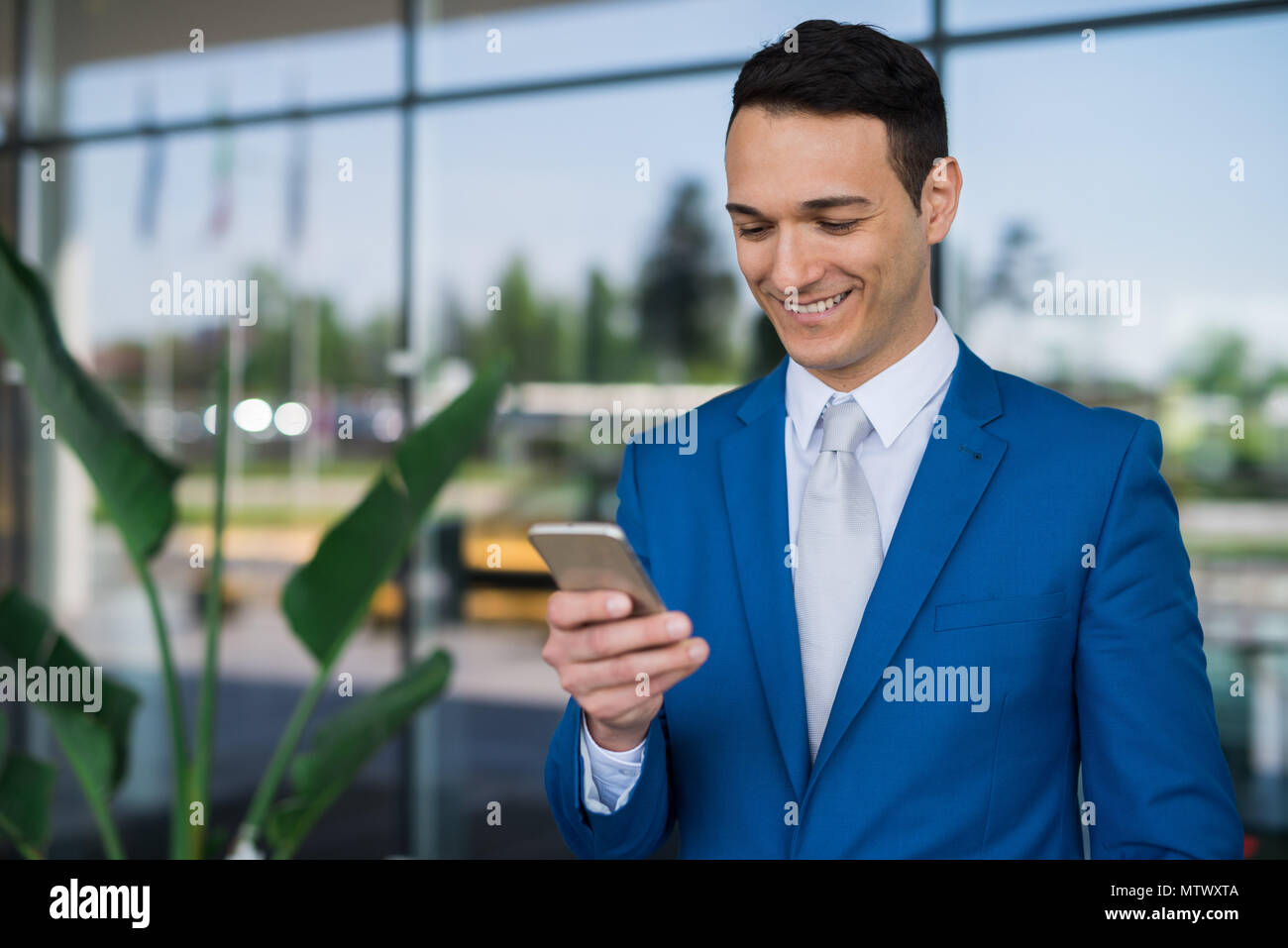 Businessman using his mobile phone Stock Photo - Alamy