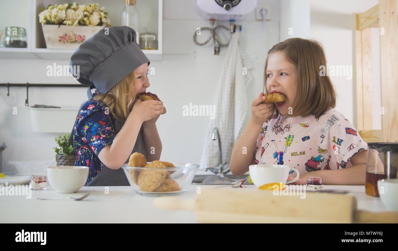 Two girls eats cookies with jam prepared with their own hands Stock ...