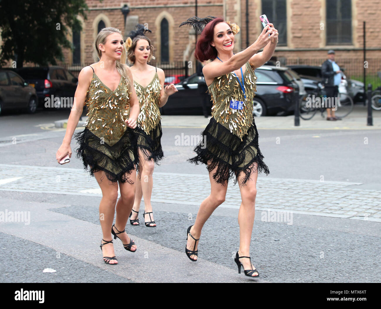 A dancer films a selfie whilst rushing into the Hammersmith Apollo ...