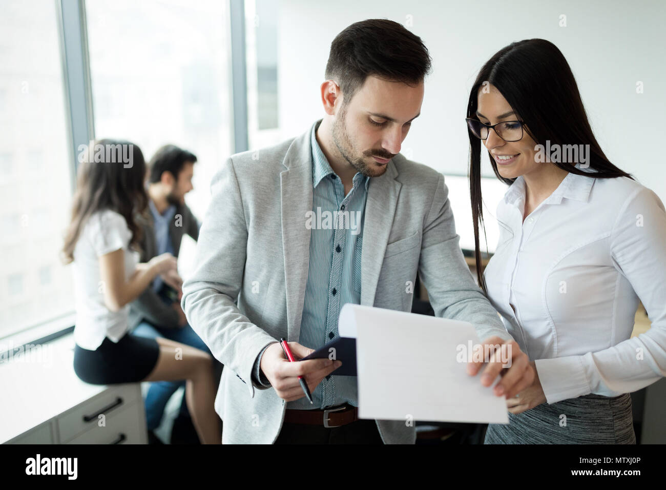 Picture of business people discussing in office Stock Photo - Alamy