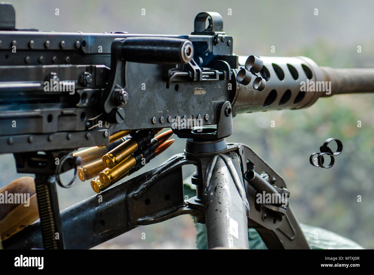 (FORT BENNING, GA) - Belt links eject as .50 Caliber rounds feed into ...